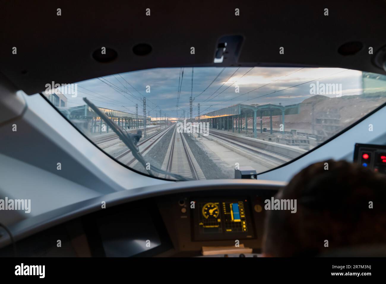 Motion blur view of railway from inside high speed train at evening and ...
