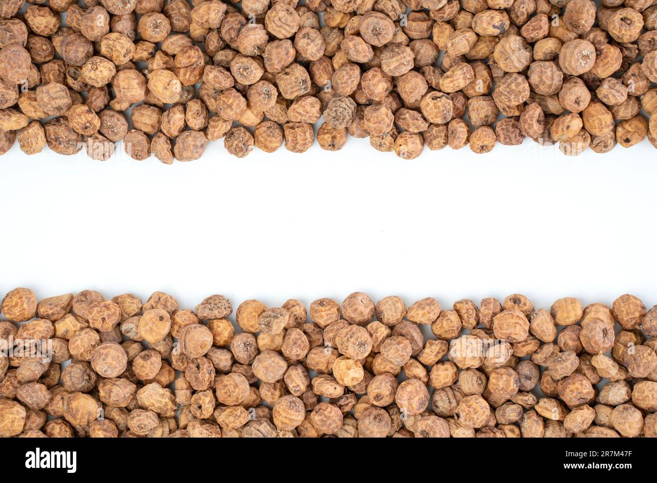 Top view of a of tigernuts on a white background with copy space in the ...