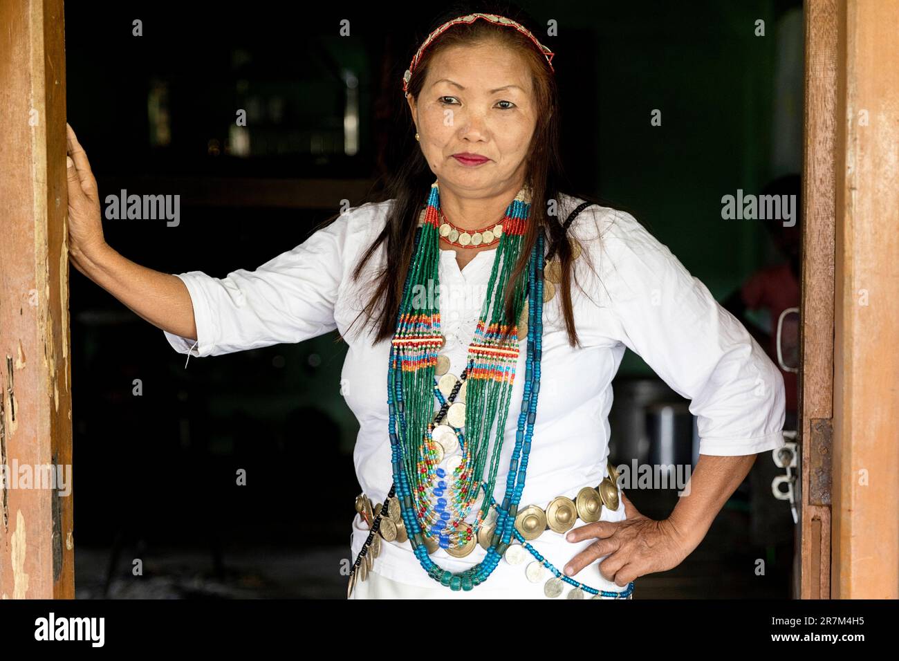 Woman from Galo tribe weaing traditional white dress and jewelry in her ...