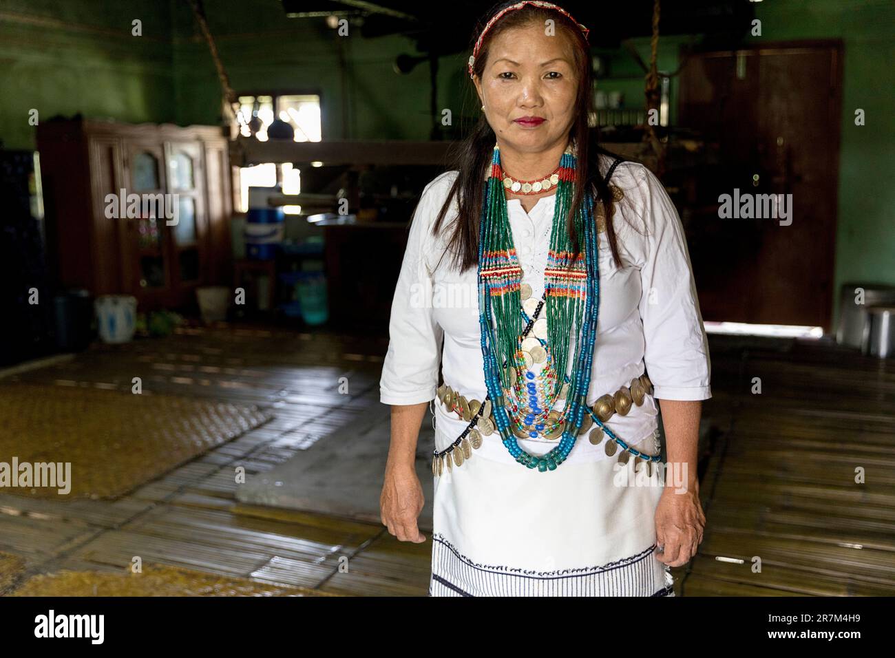 Woman from Galo tribe weaing traditional white dress and jewelry in her ...