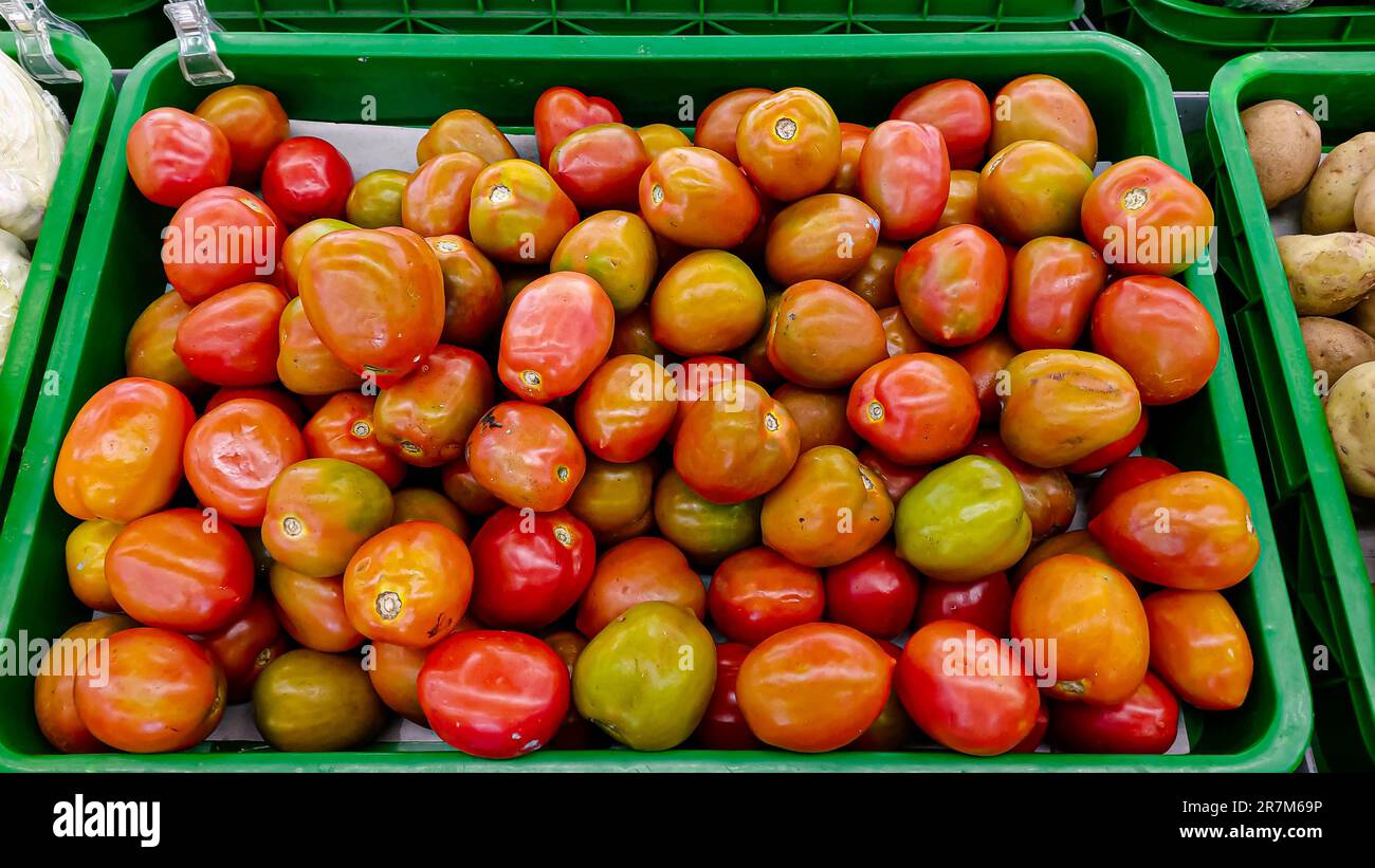 A group of tomatoes in a box. Tomatoes background in a box Stock Photo ...
