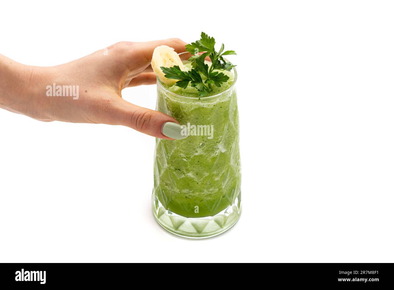 A hand grabbing a glass with a delicious healthy fruit smoothie ...