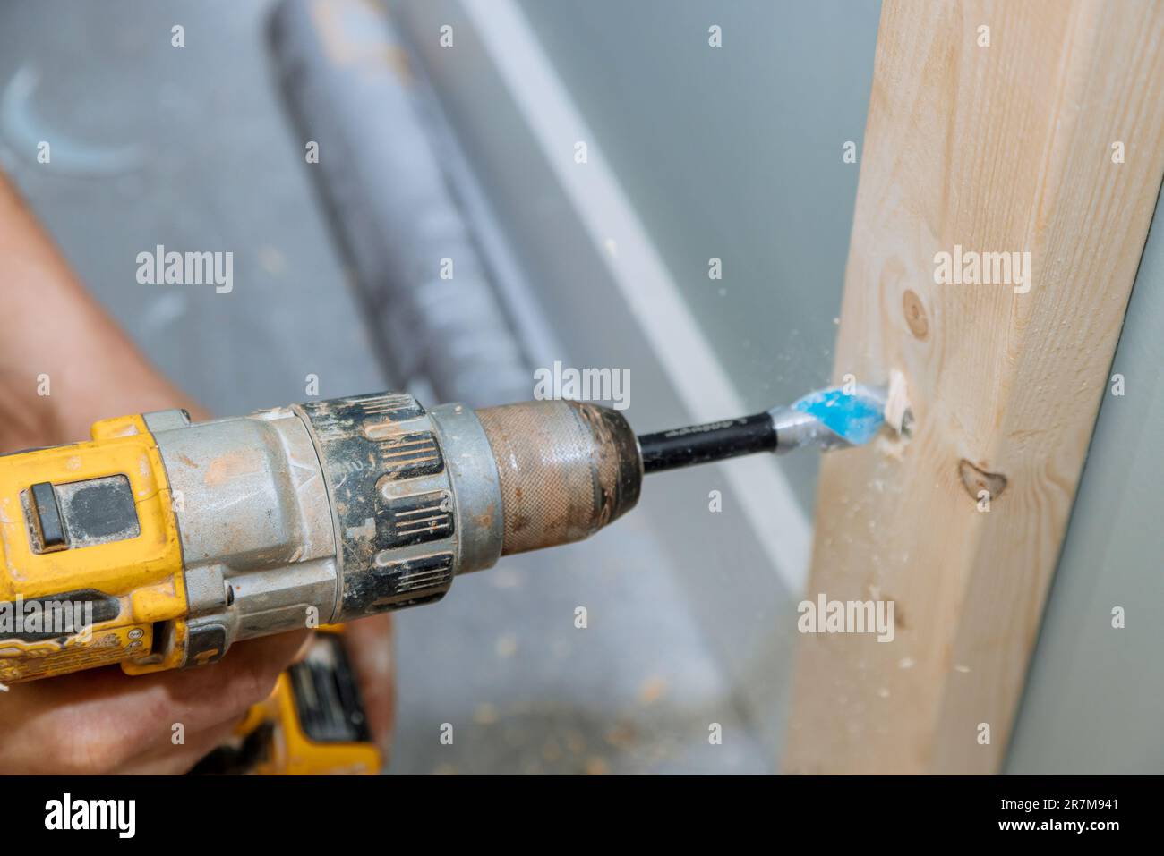 Process of drilling hole in wall in order to allow cable to be laid ...