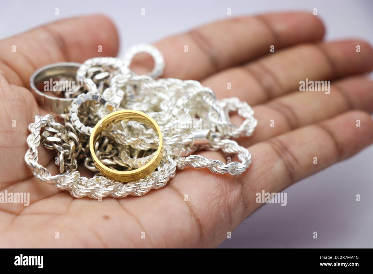silver and gold ornaments held in the hand. Latest design silver chains ...
