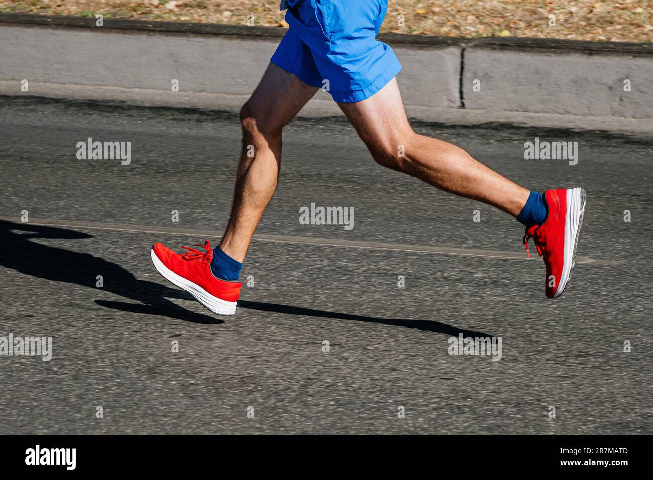 legs male runner running city marathon race, contrasting jogger shadow ...