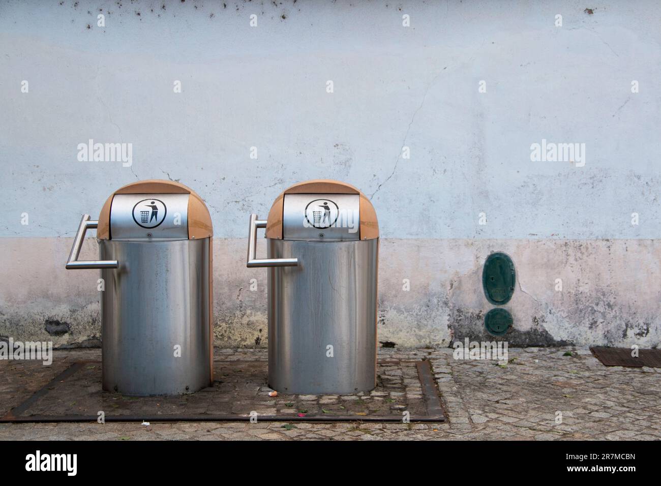 Garbage bins made of steel and fixed to the floor with the logo of the ...