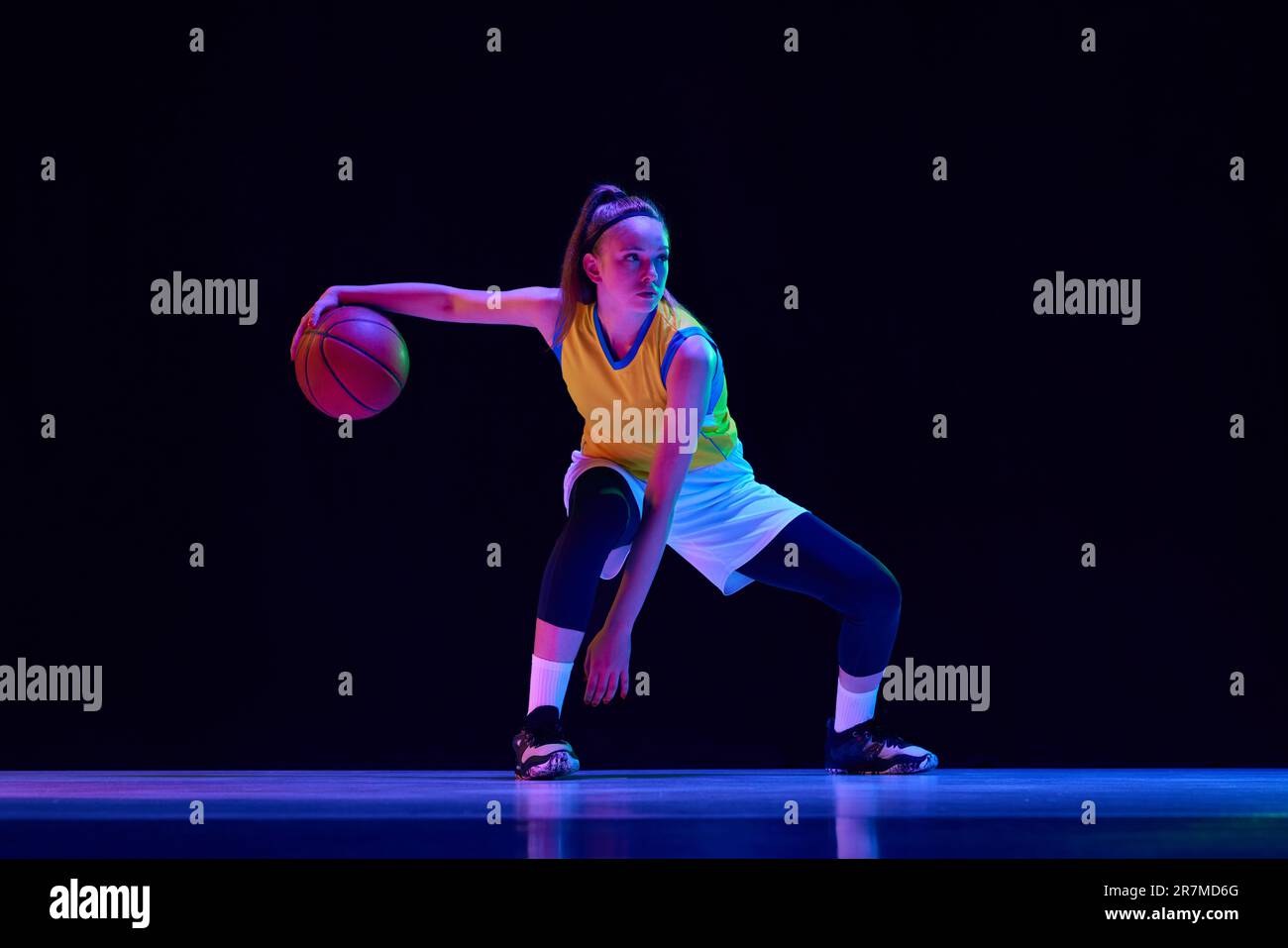 Dribbling. Young girl, basketball player in motion during game against ...