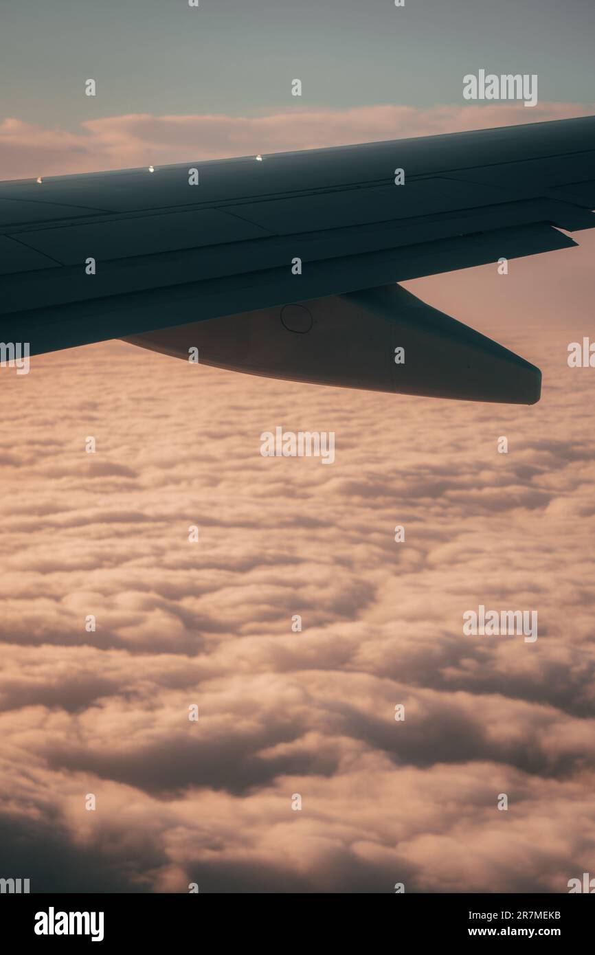 Airplane wing soaring above clouds, a sublime moment where the Earth ...