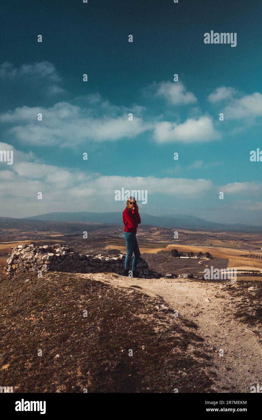 In a sun-kissed landscape, a person poses, embodying the harmonious ...