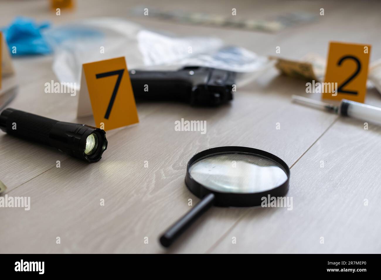 Crime scene concept with a gun and evidence markers high contrast image ...