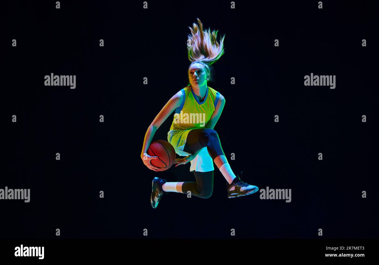 Dynamic image of motivated sportsman, young girl playing basketball ...