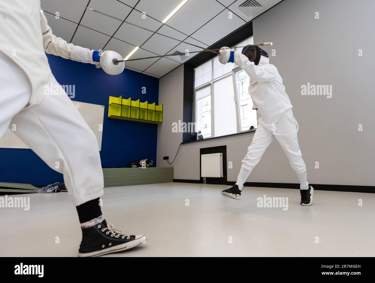 Two girl fencing athletes fight on professional sports arena Stock ...