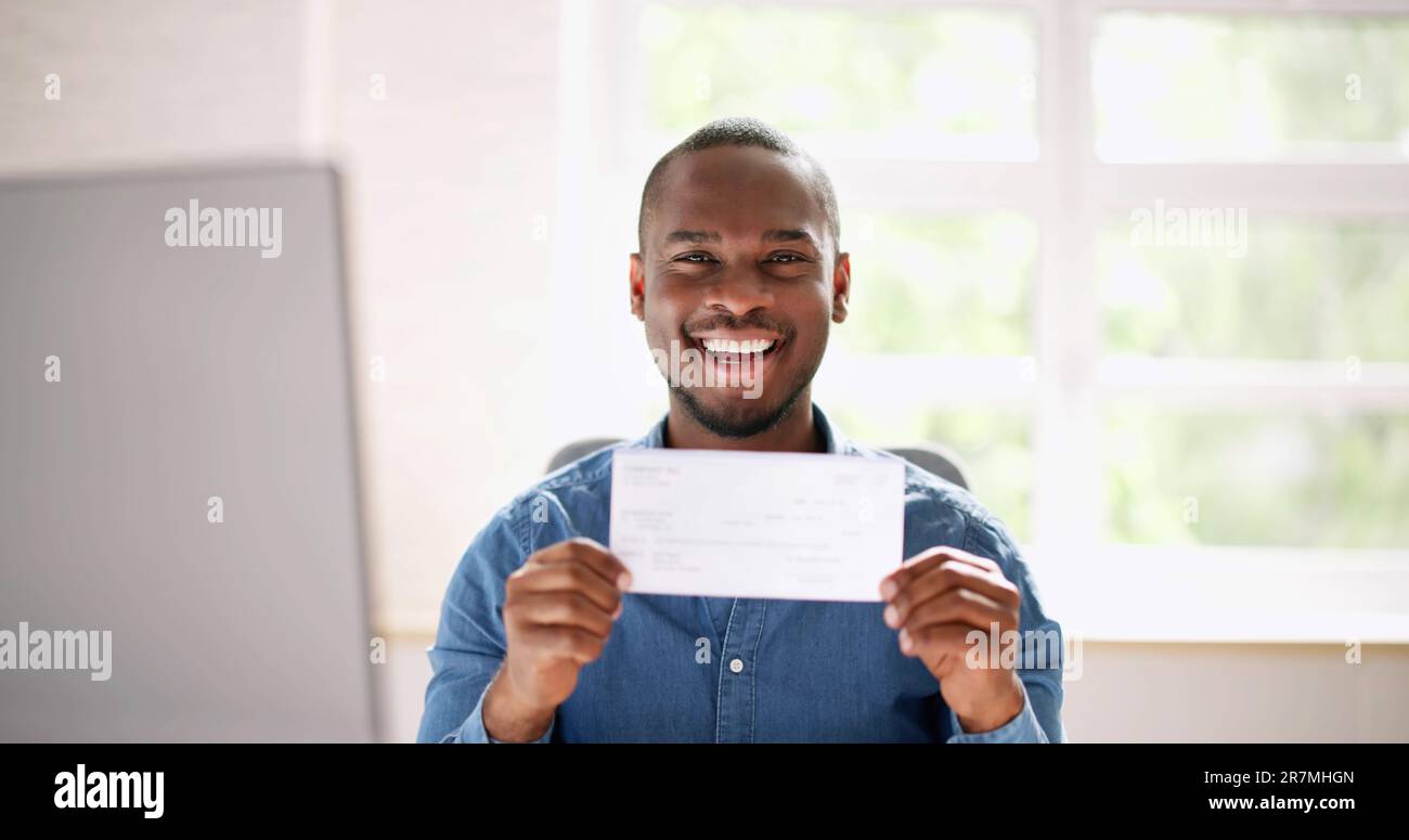 Black man holding cheque hi-res stock photography and images - Alamy