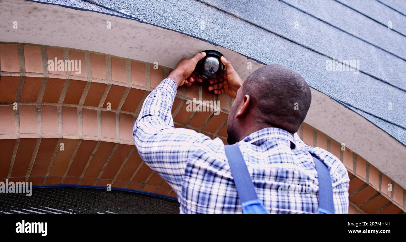 African American Handyman CCTV Camera Installer On Ladder Stock Photo ...