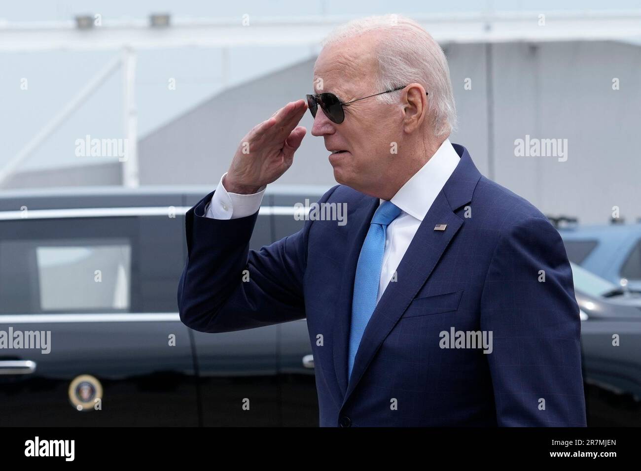 President Joe Biden returns a salute as he arrives at Bradley ...