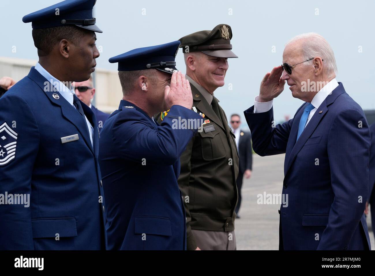 President Joe Biden returns a salute as he arrives at Bradley ...