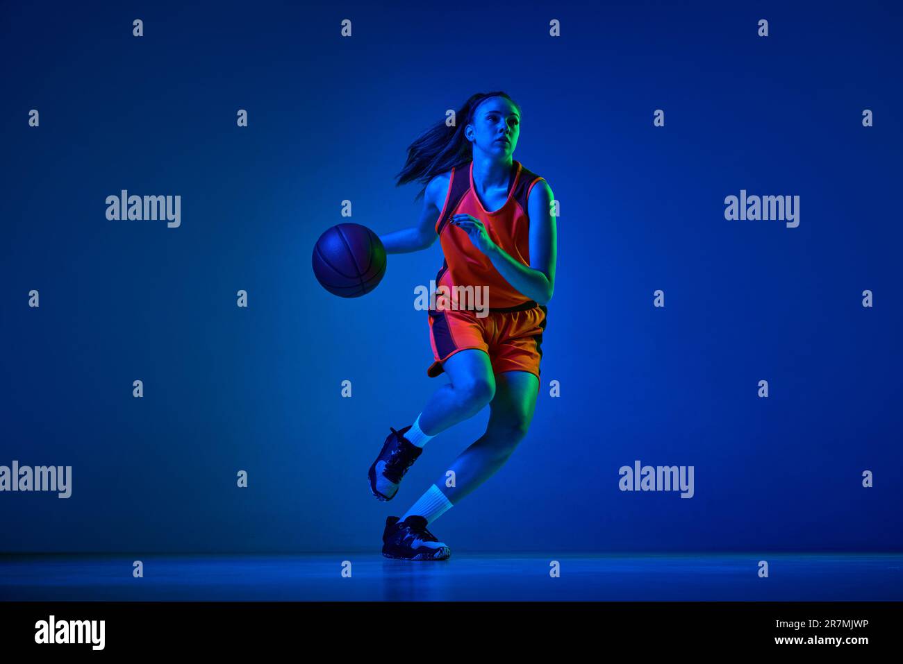 Dynamic image of young girl, basketball player in uniform in motion ...