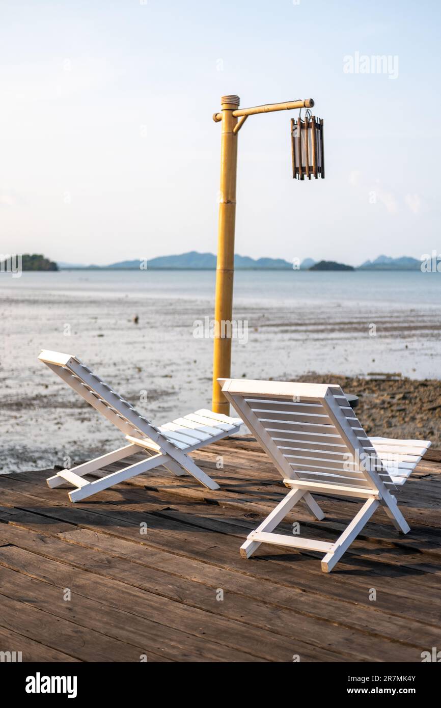 Outdoor seating on the terrace, with bamboo lamp post. With view of the ...
