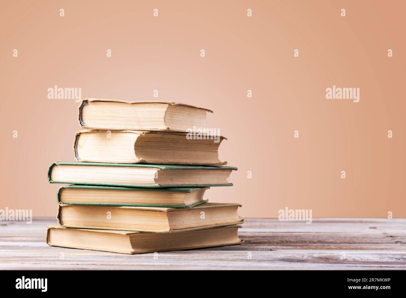 Book with opened pages in shape of heart and stacked books on reading ...