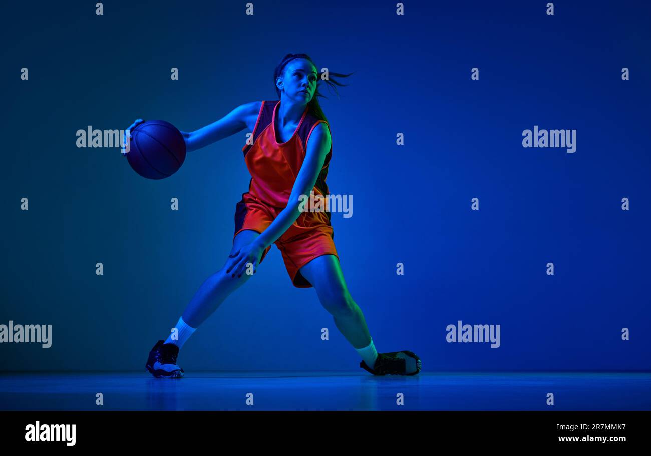 Dynamic image of young girl, basketball player in uniform in motion ...