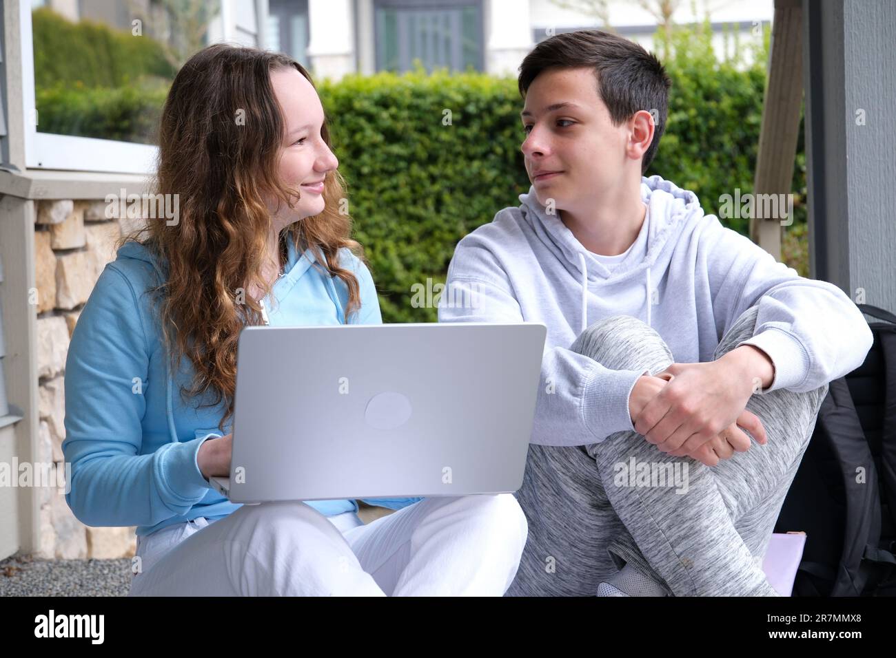 do homework together peep boy and girl sit next to cups of tea in ...