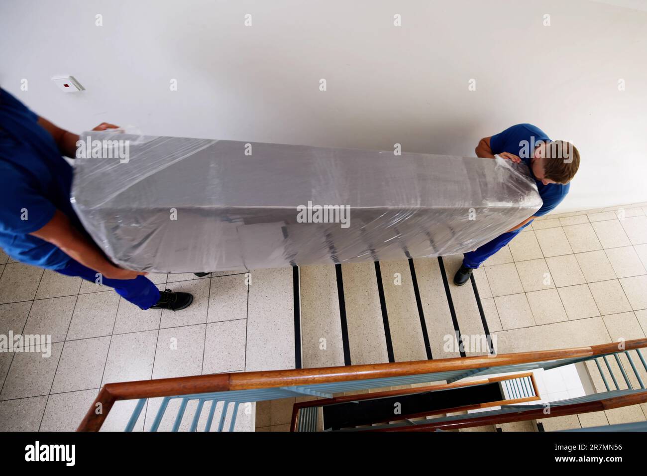Moving Service Workers In Uniform Walking House Stairs Stock Photo - Alamy
