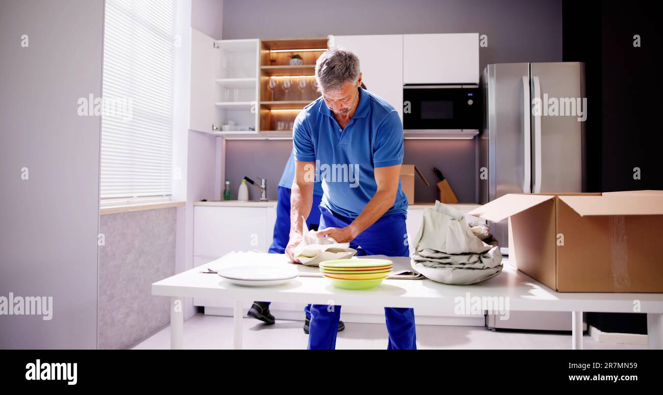 Packing Dishes In Home Apartment Room. Moving Service Stock Photo - Alamy