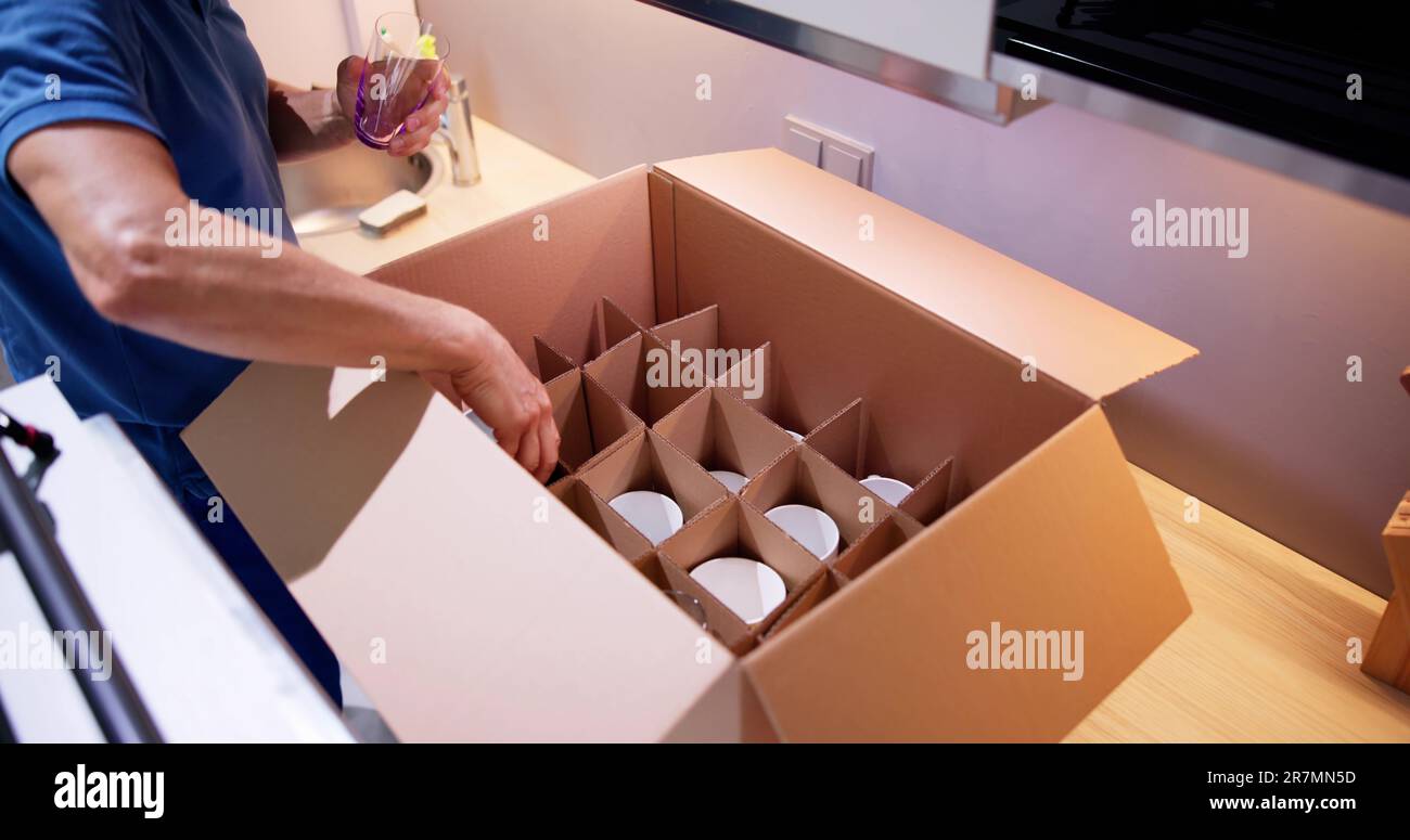 Packing Glasses At Home Apartment Room. Moving Service Stock Photo - Alamy