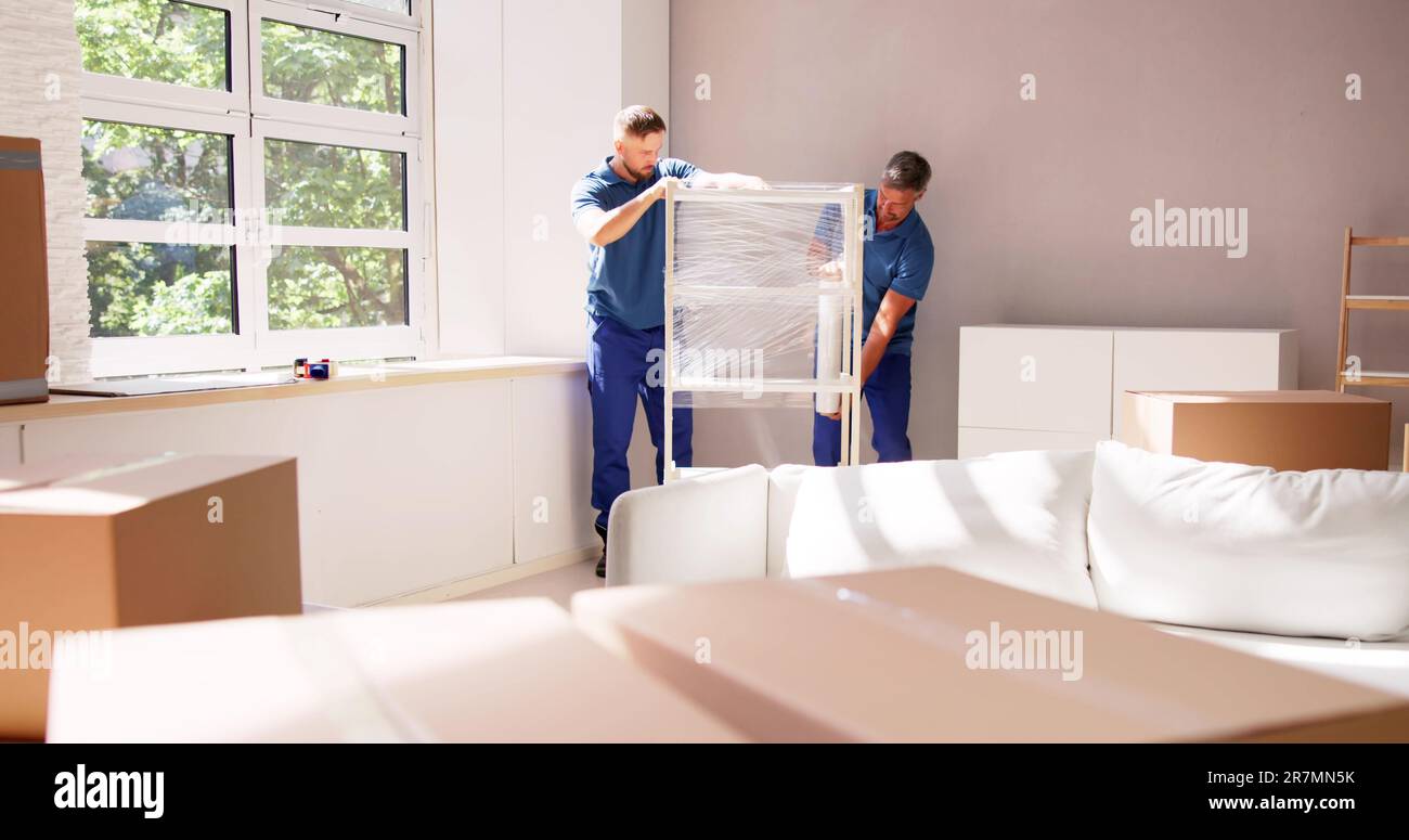 Professional Furniture Movers Wrapping. House Packing Service Stock ...