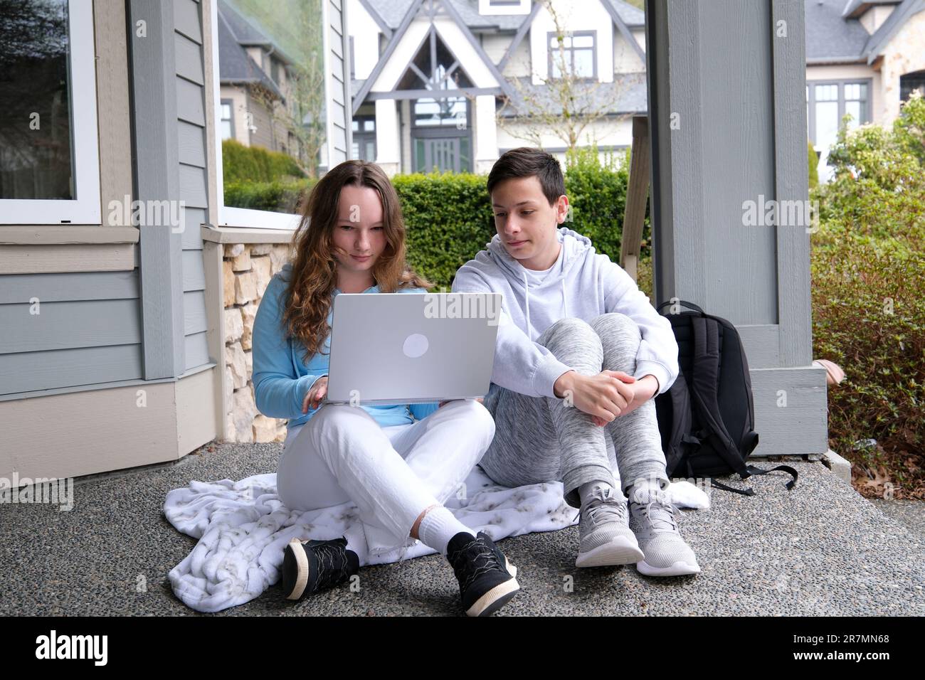 do homework together peep boy and girl sit next to cups of tea in ...
