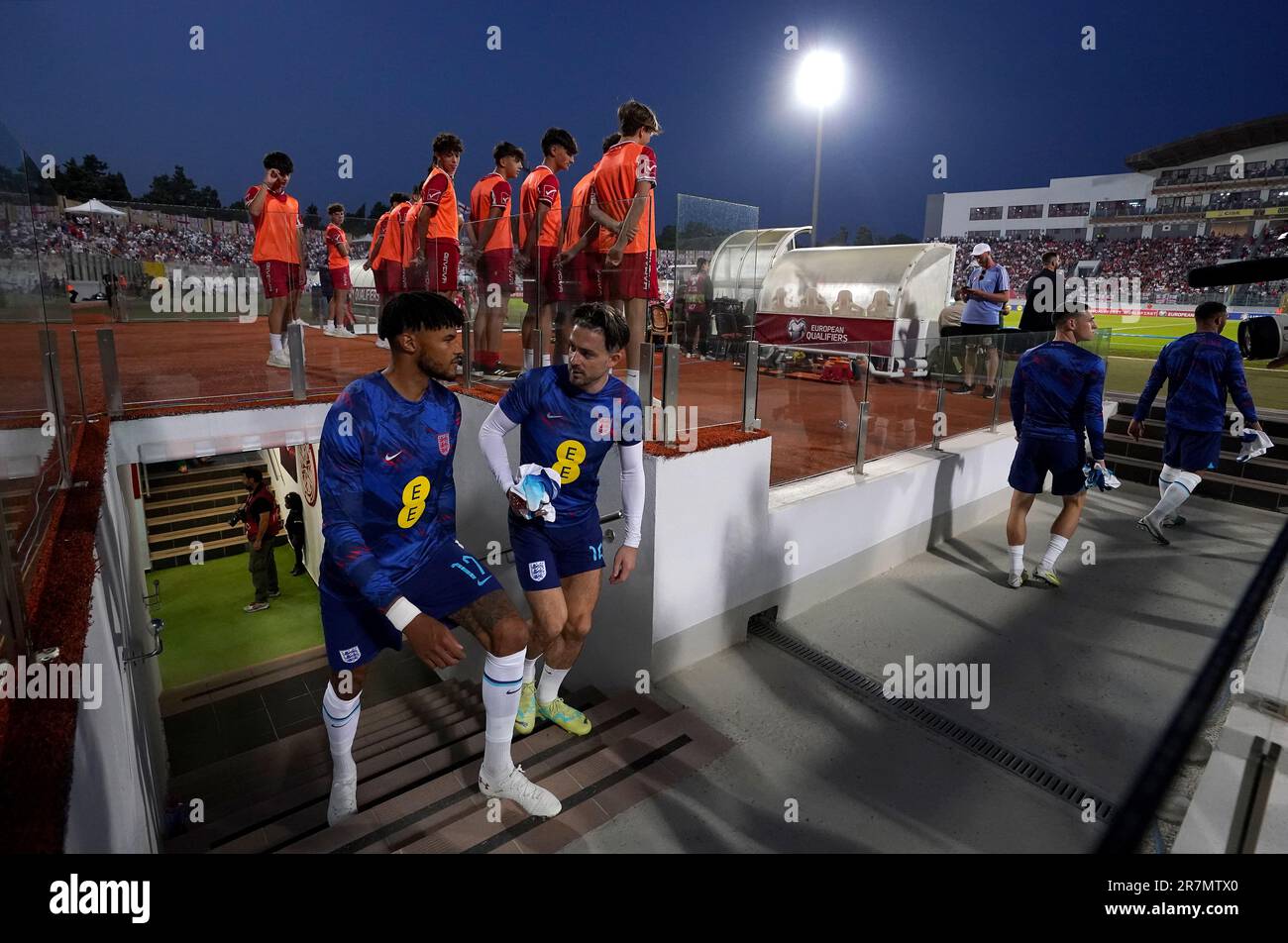 England's Tyrone Mings (left) and Jack Grealish walk out of the tunnel ...