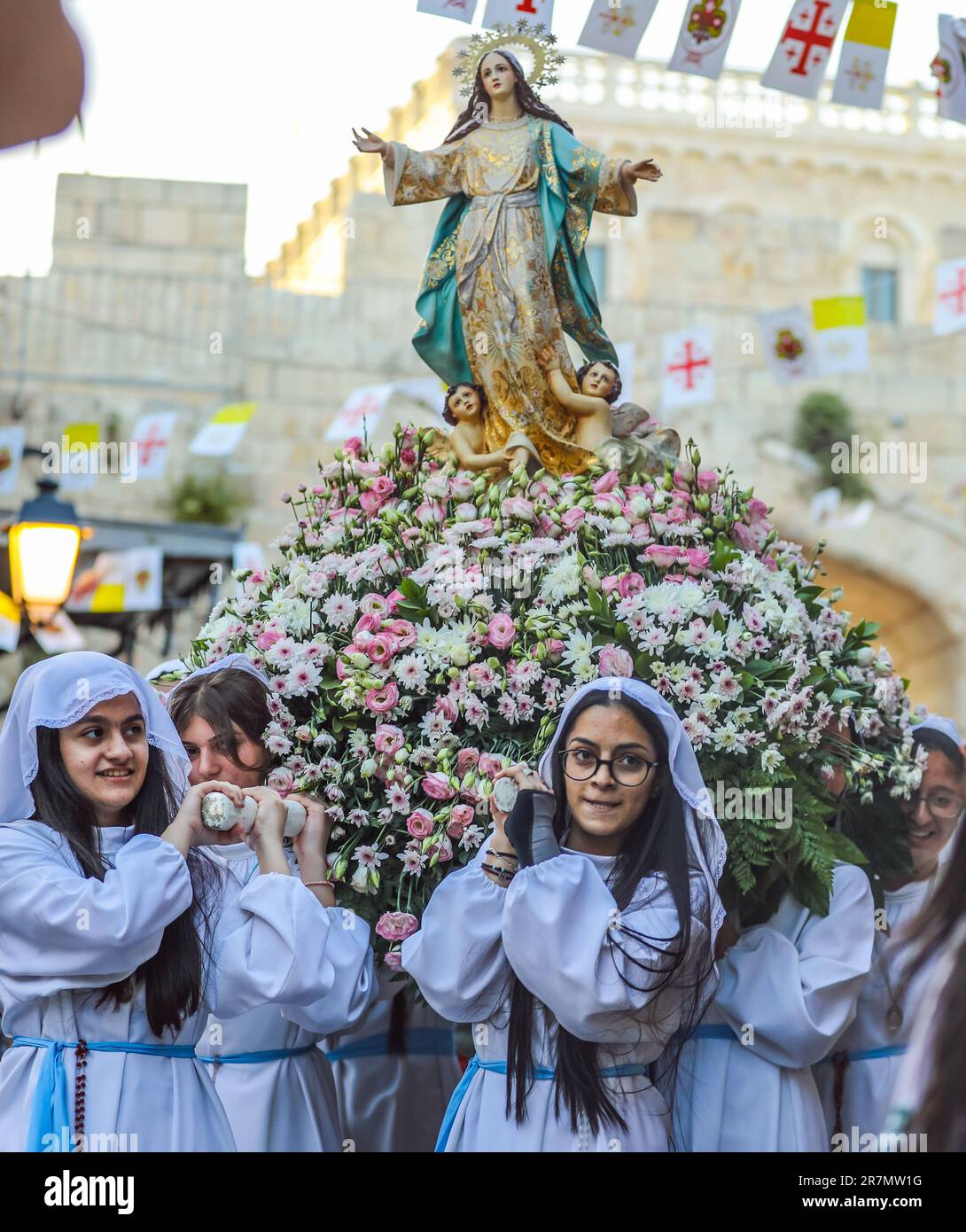 Young Catholic maidens, dressed in white, carrying an icon of the ...