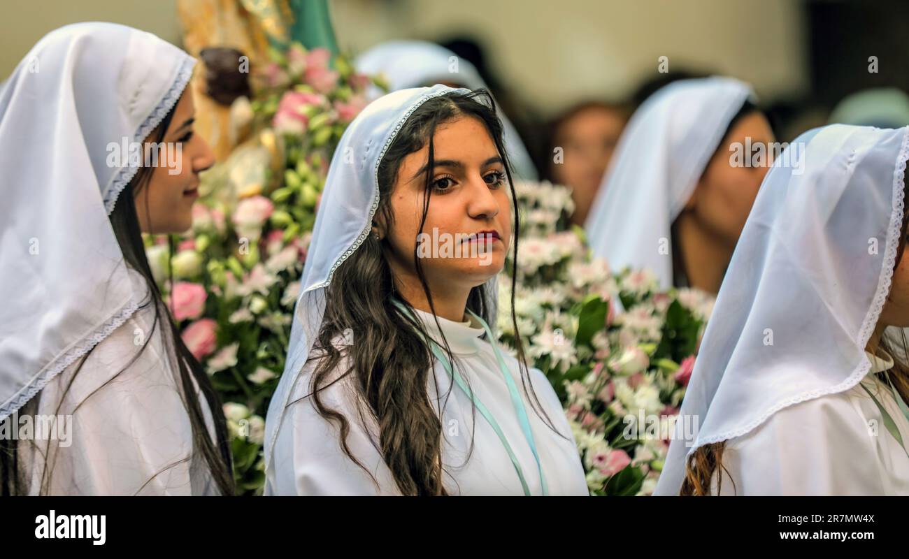 Young Catholic maidens, dressed in white, carrying an icon of the ...