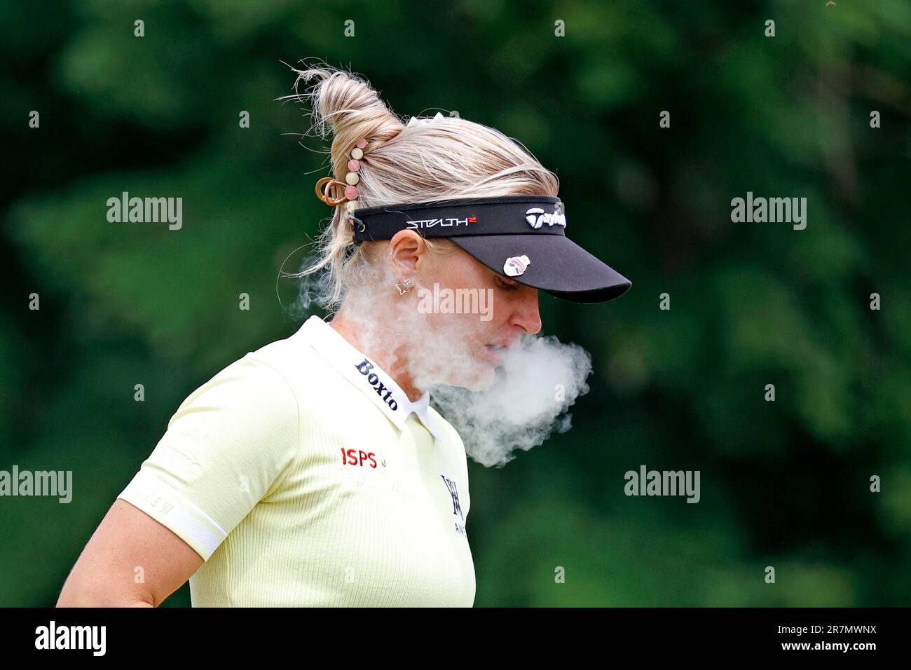 GRAND RAPIDS, MI - JUNE 16: LPGA golfer Charley Hull blows smoke from ...