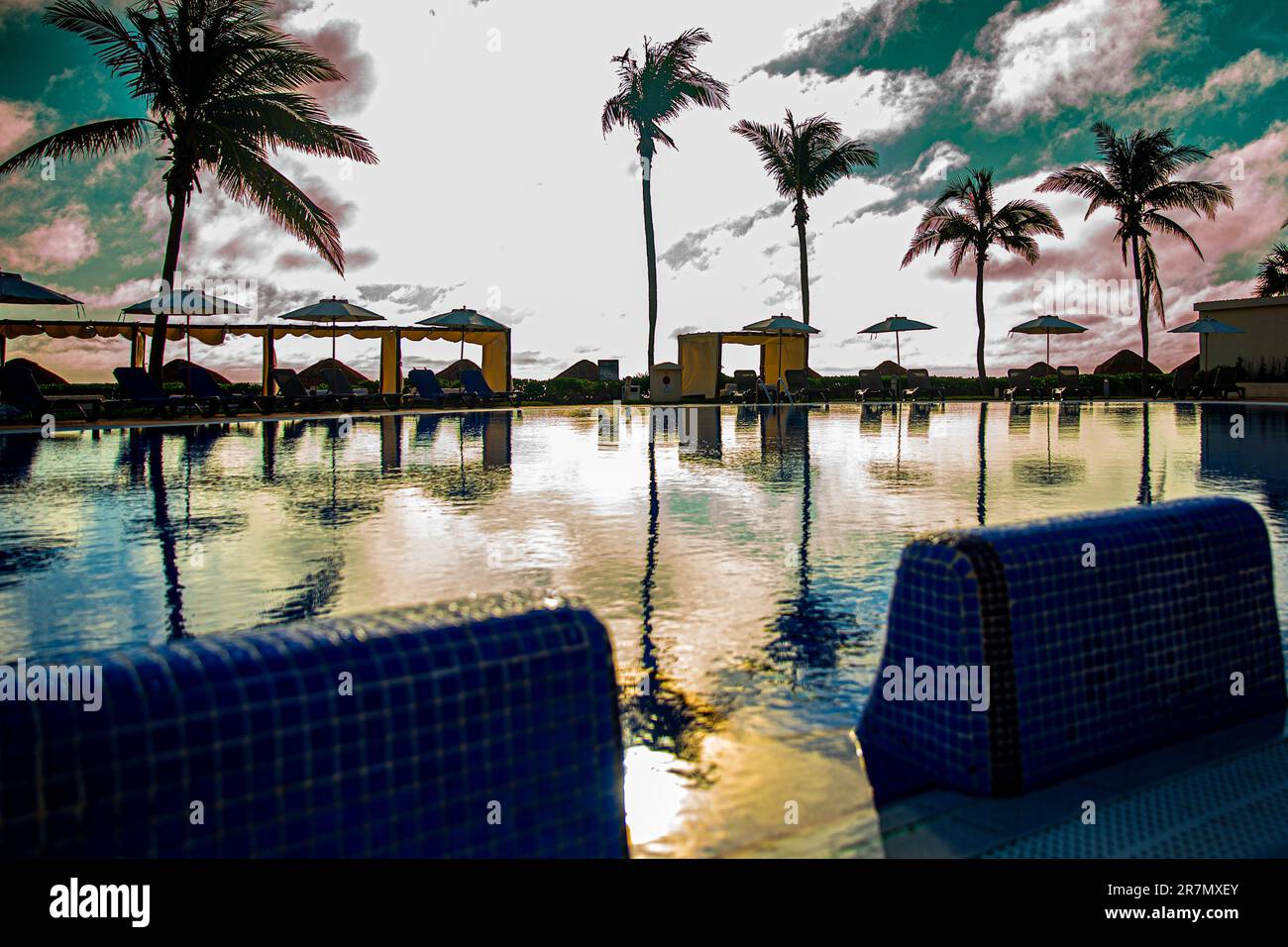 Infinity pool with jacuzzis in the morning light Stock Photo - Alamy