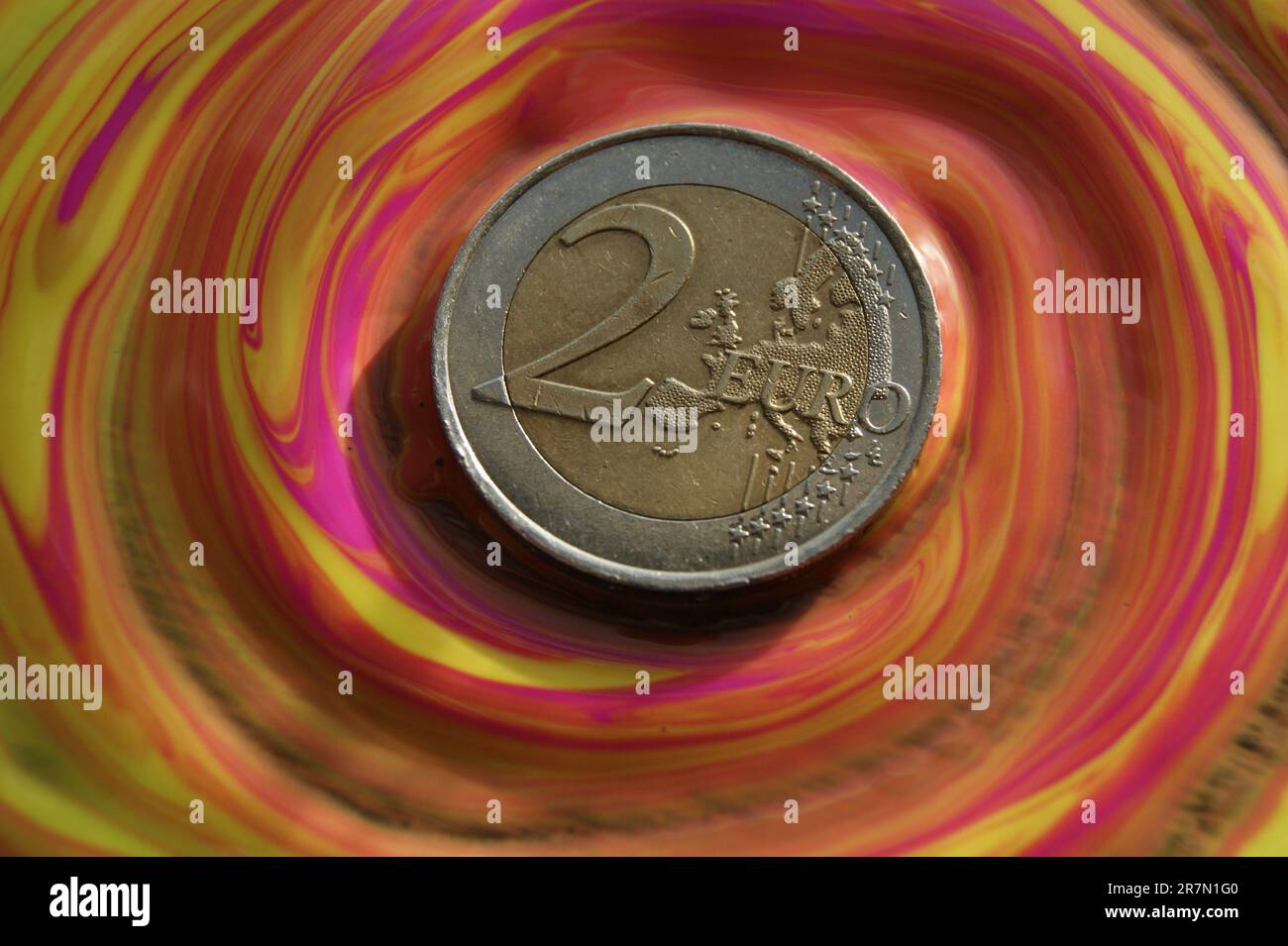 2 euro coin on an abstract colorful background. European currency ...