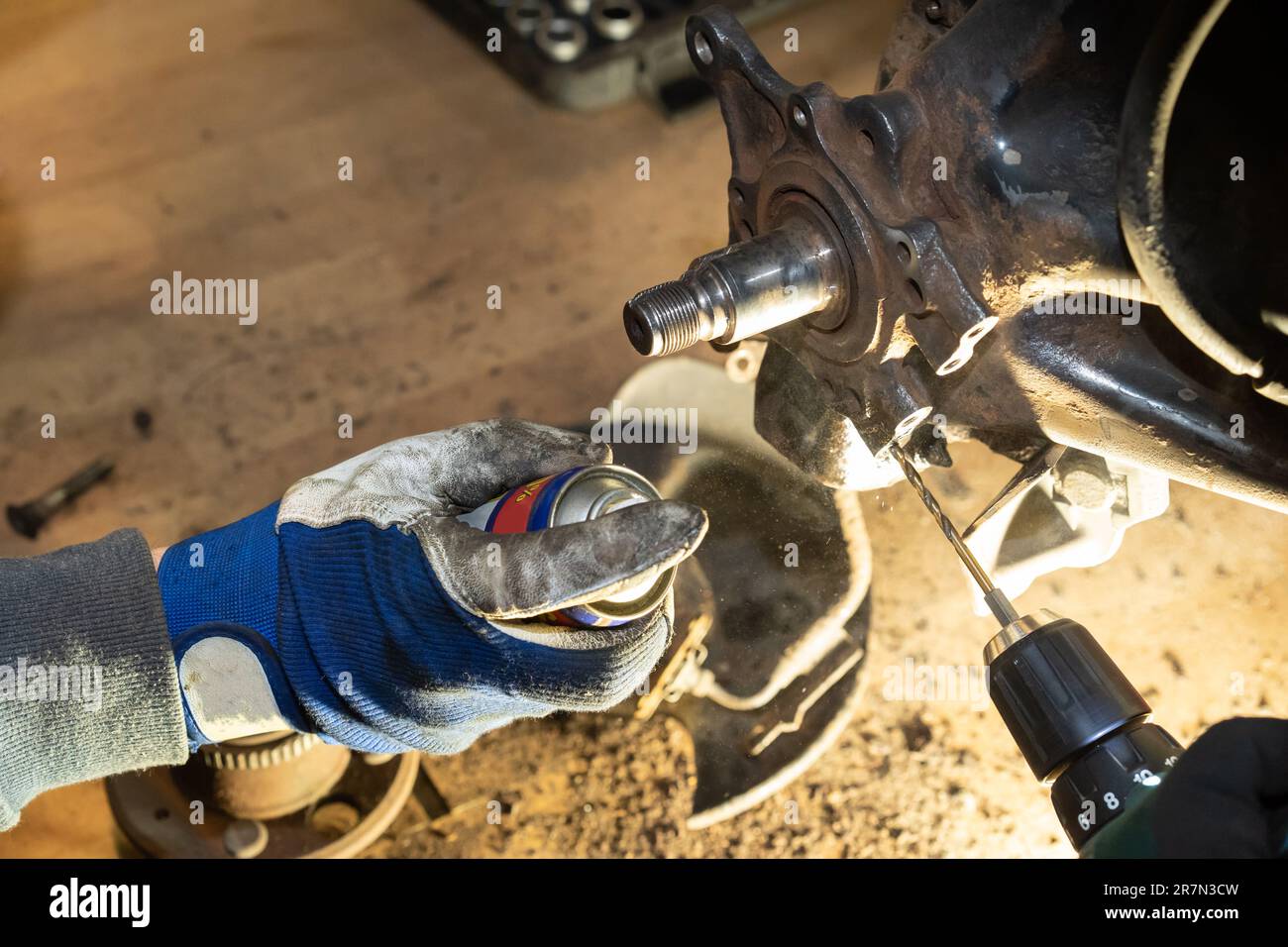 Auto mechanics repair wheel hub bearing. In the process of tapping and cooling Stock Photo - Alamy