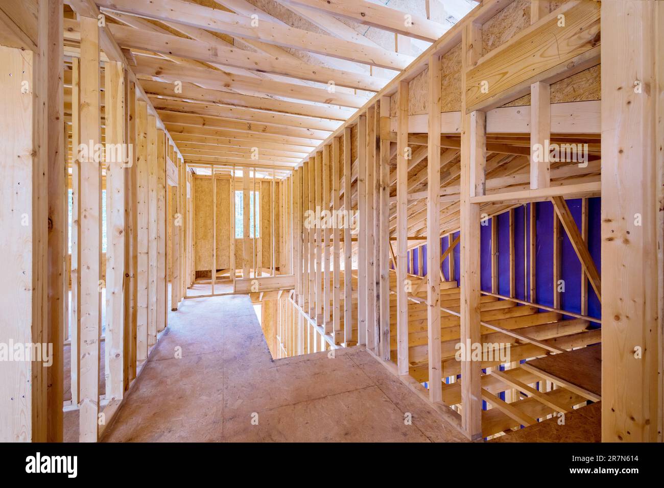 An inside view of new house incomplete wooden framing beams Stock Photo ...