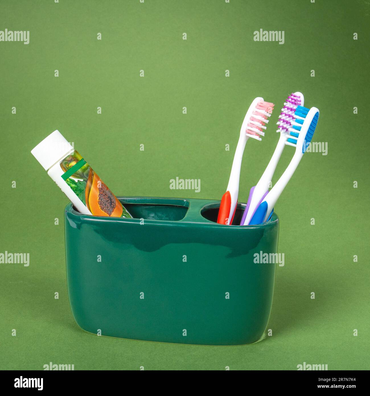 A set of three multi-colored toothbrushes, a tube of eco-friendly ...