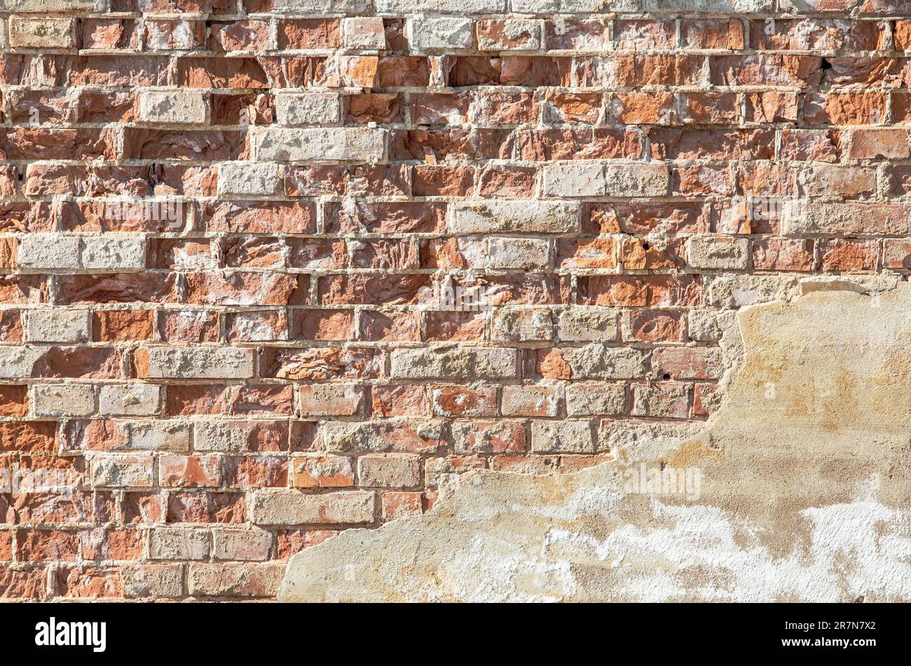 Old fortress wall made of dilapidated bricks with the remains of ...