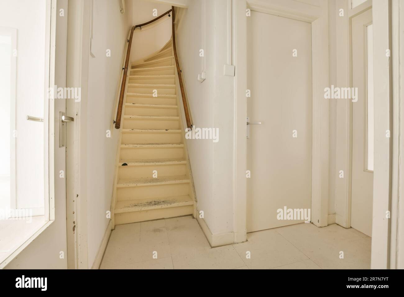 an empty room with stairs leading up to the second floor and another ...