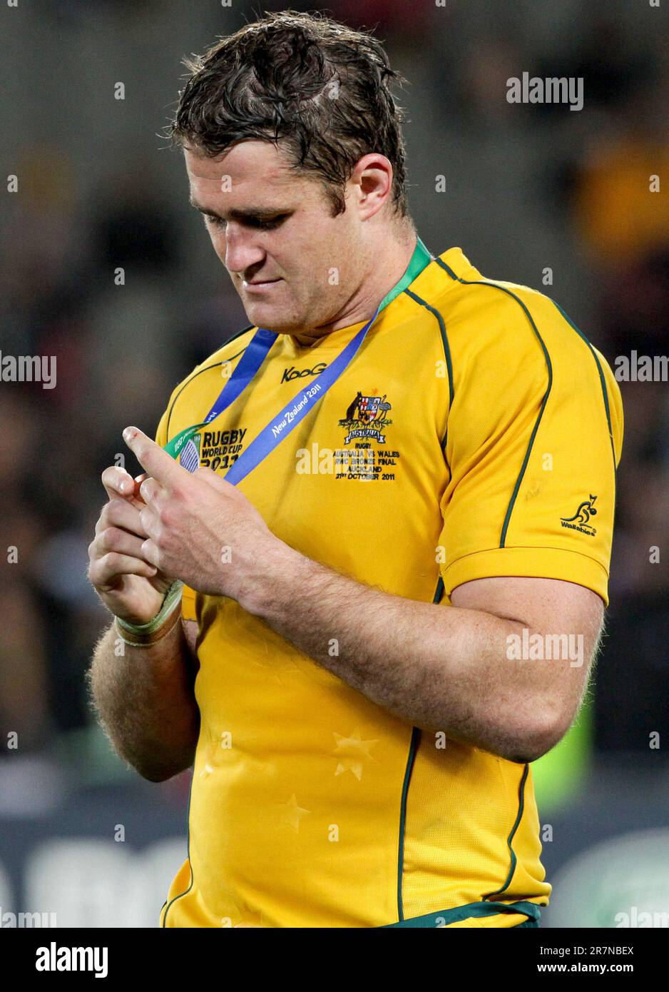 Australia’s captain James Horwill studies at his bronze medal after ...