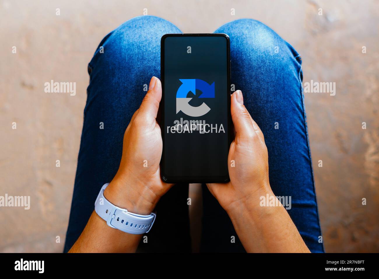 In this photo illustration, the reCAPTCHA logo is displayed on a smartphone screen Stock Photo ...