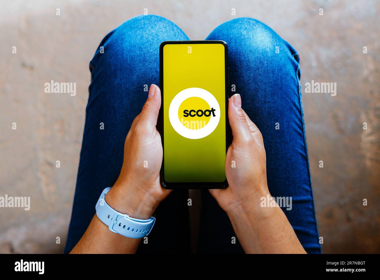 In this photo illustration, the Scoot logo is displayed on a smartphone ...