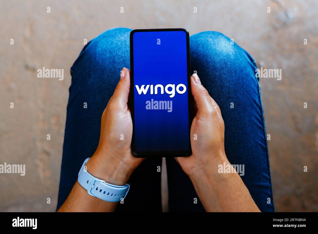 In this photo illustration, the Wingo logo is displayed on a smartphone ...