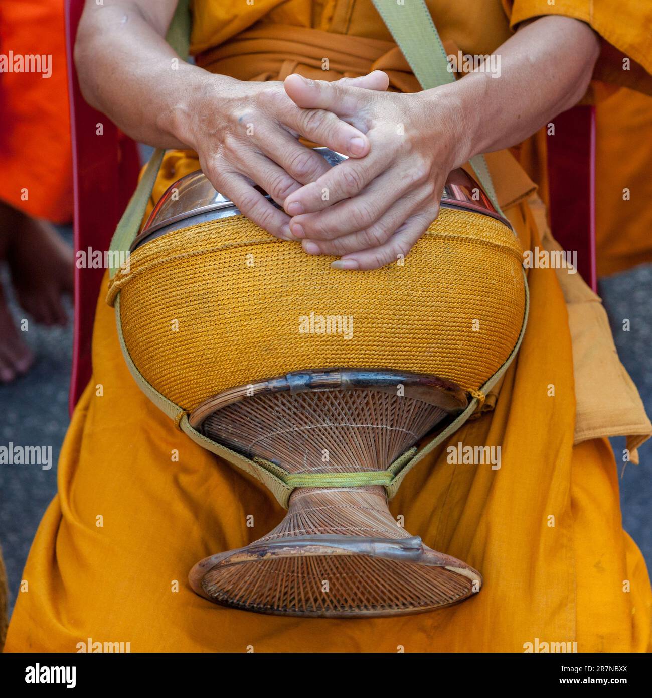 Thai Buddhist monk's alms bowl in hands closeup Stock Photo - Alamy