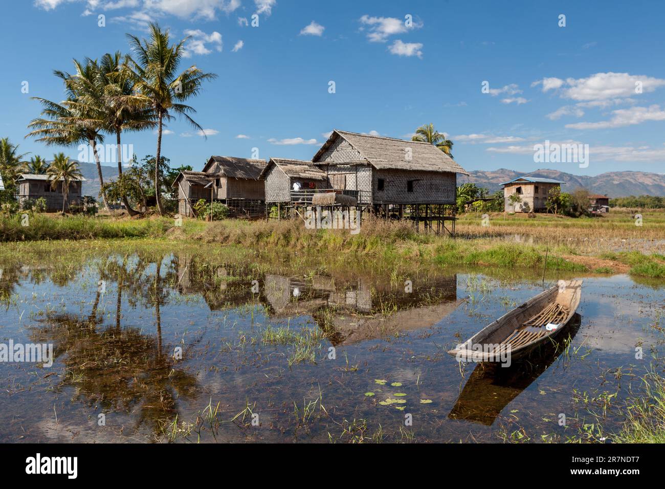 Simple bamboo houses and old boat on Inle Lake in Myanmar Stock Photo ...