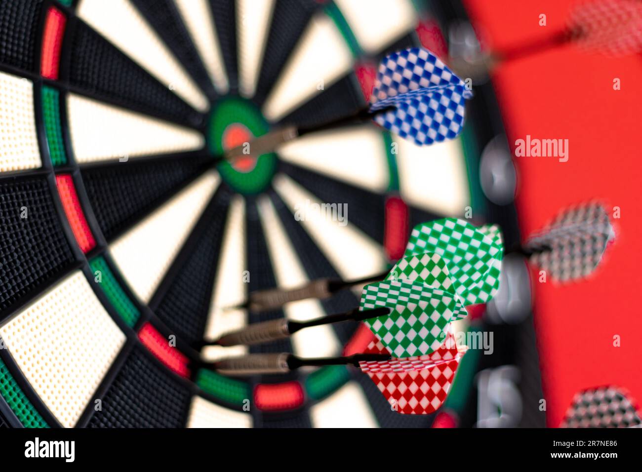Three black and red darts are displayed with checkered designs on their ...