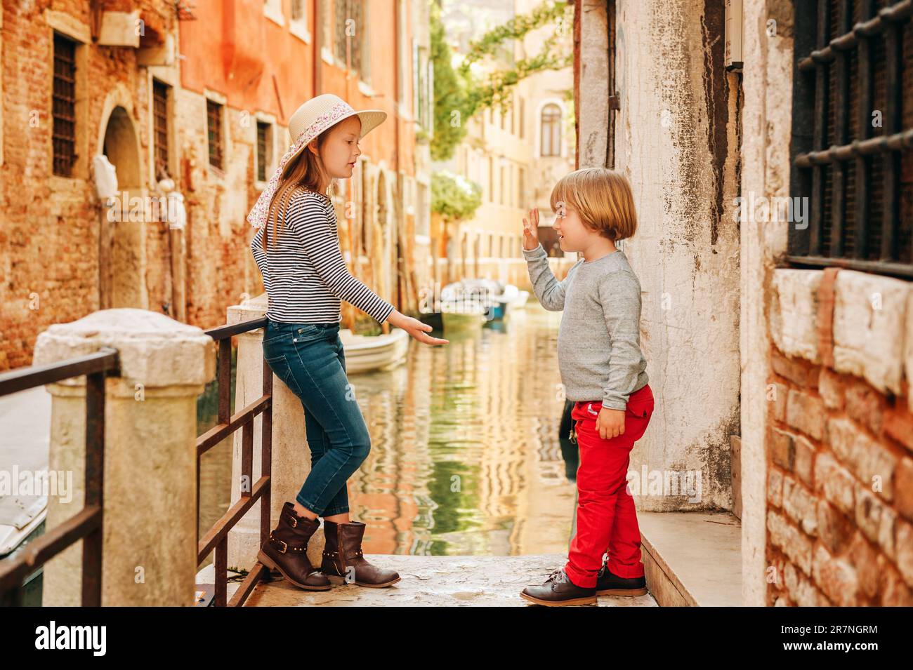 Two kids playing on the bridge in Venice. Little girl and boy visiting ...