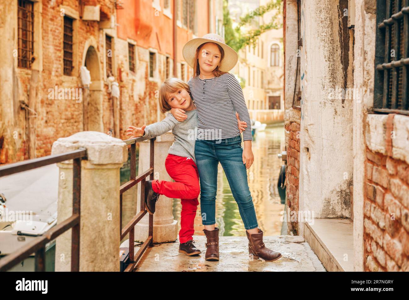 Two kids playing on the bridge in Venice. Little girl and boy visiting ...